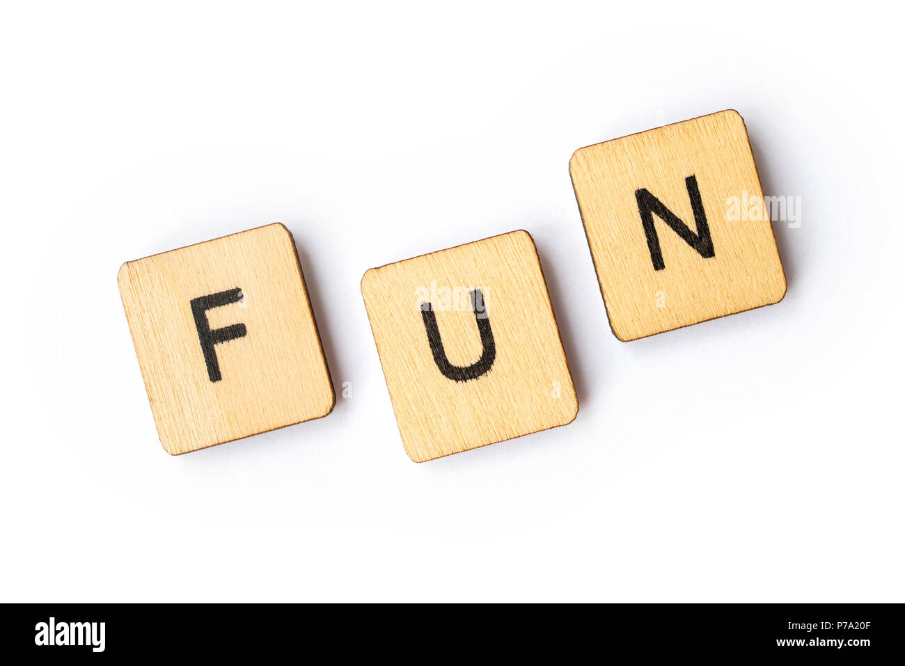 The word FUN spelt out with wooden lettered tiles Stock Photo - Alamy