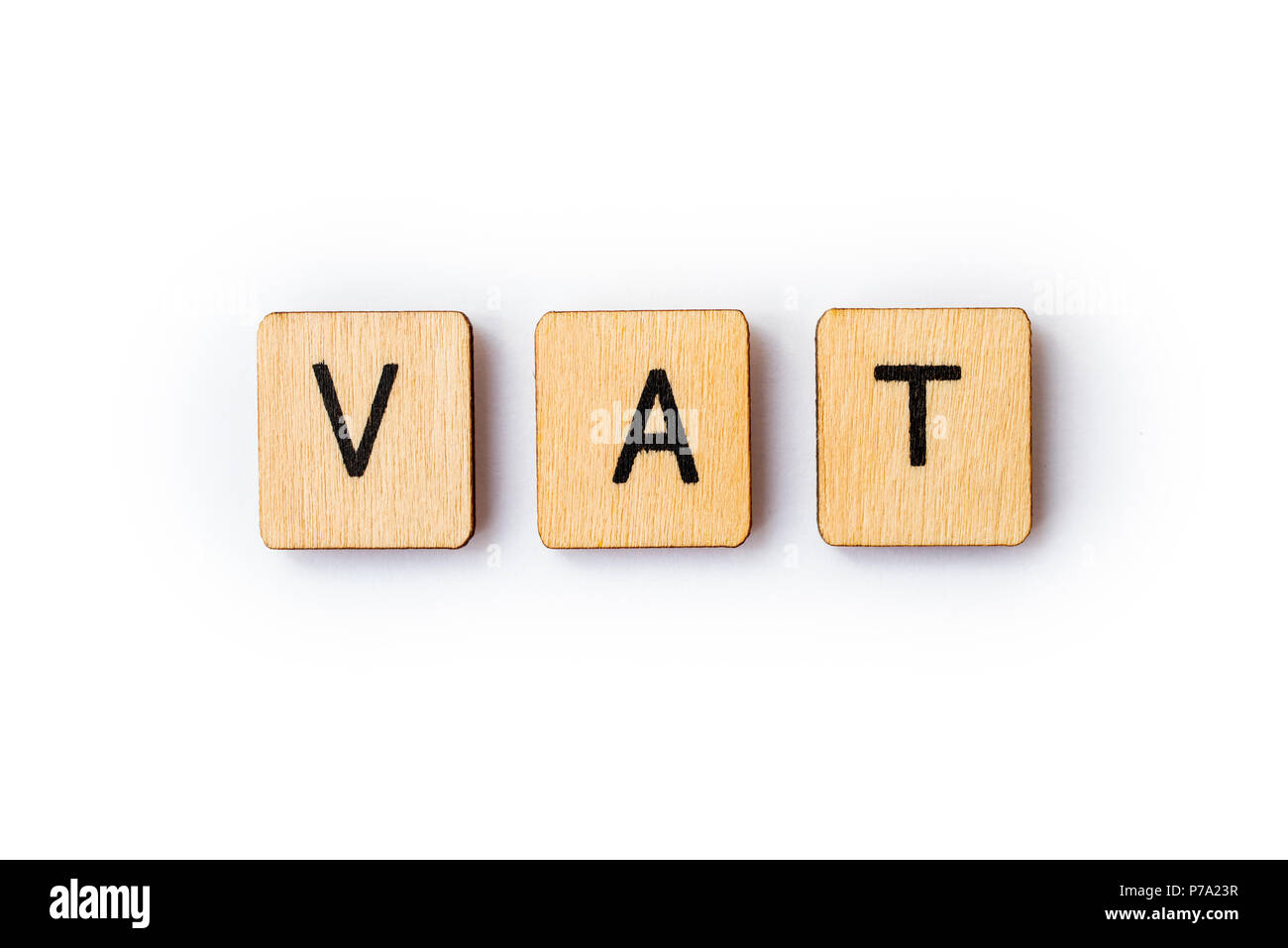 The abbreviation VAT - Value-Added Tax, spelt with wooden letter tiles ...