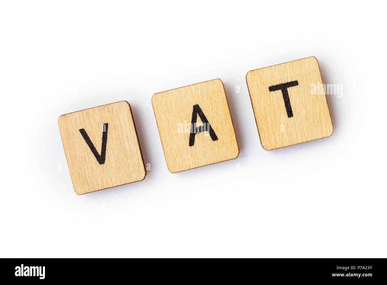 The abbreviation VAT - Value-Added Tax, spelt with wooden letter tiles ...