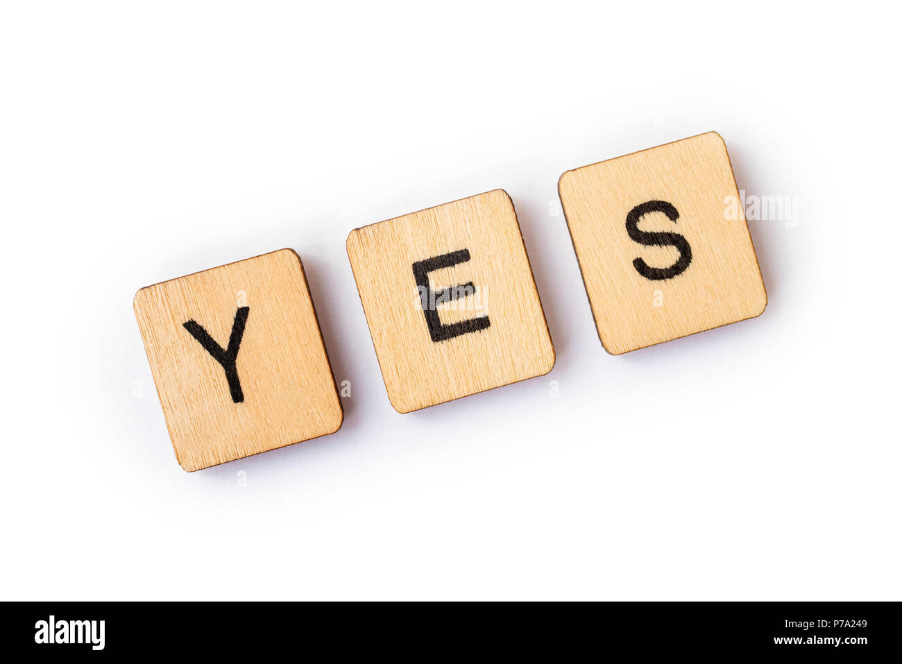 The word YES, spelt with wooden letter tiles Stock Photo - Alamy