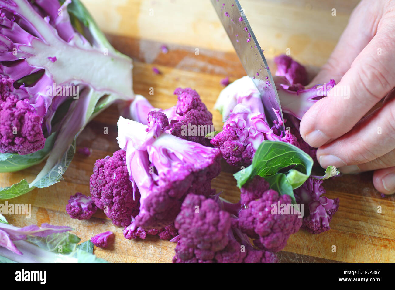 A man cuts a colorful vegetable into florets Stock Photo - Alamy