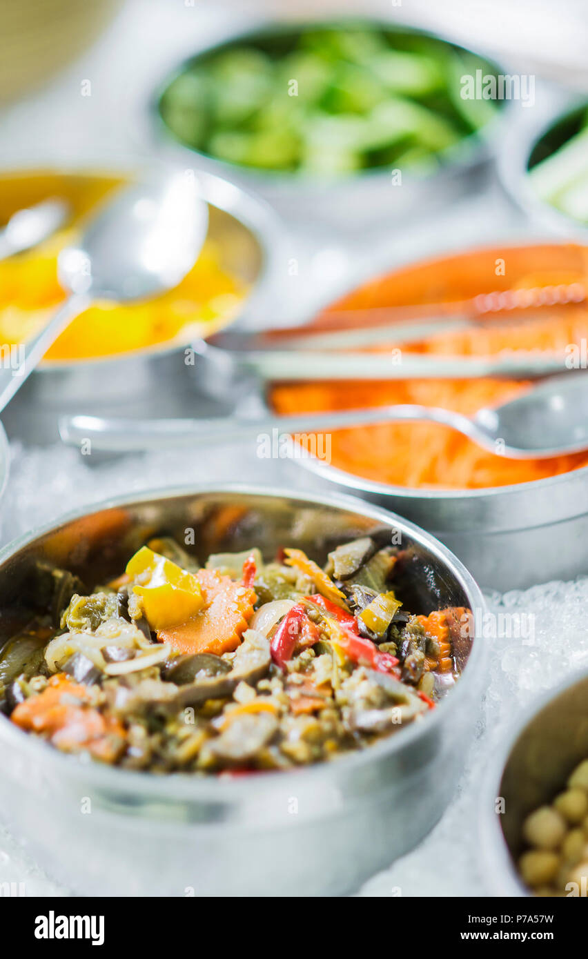 bowls of mixed fresh organic vegetables in modern salad bar display ...