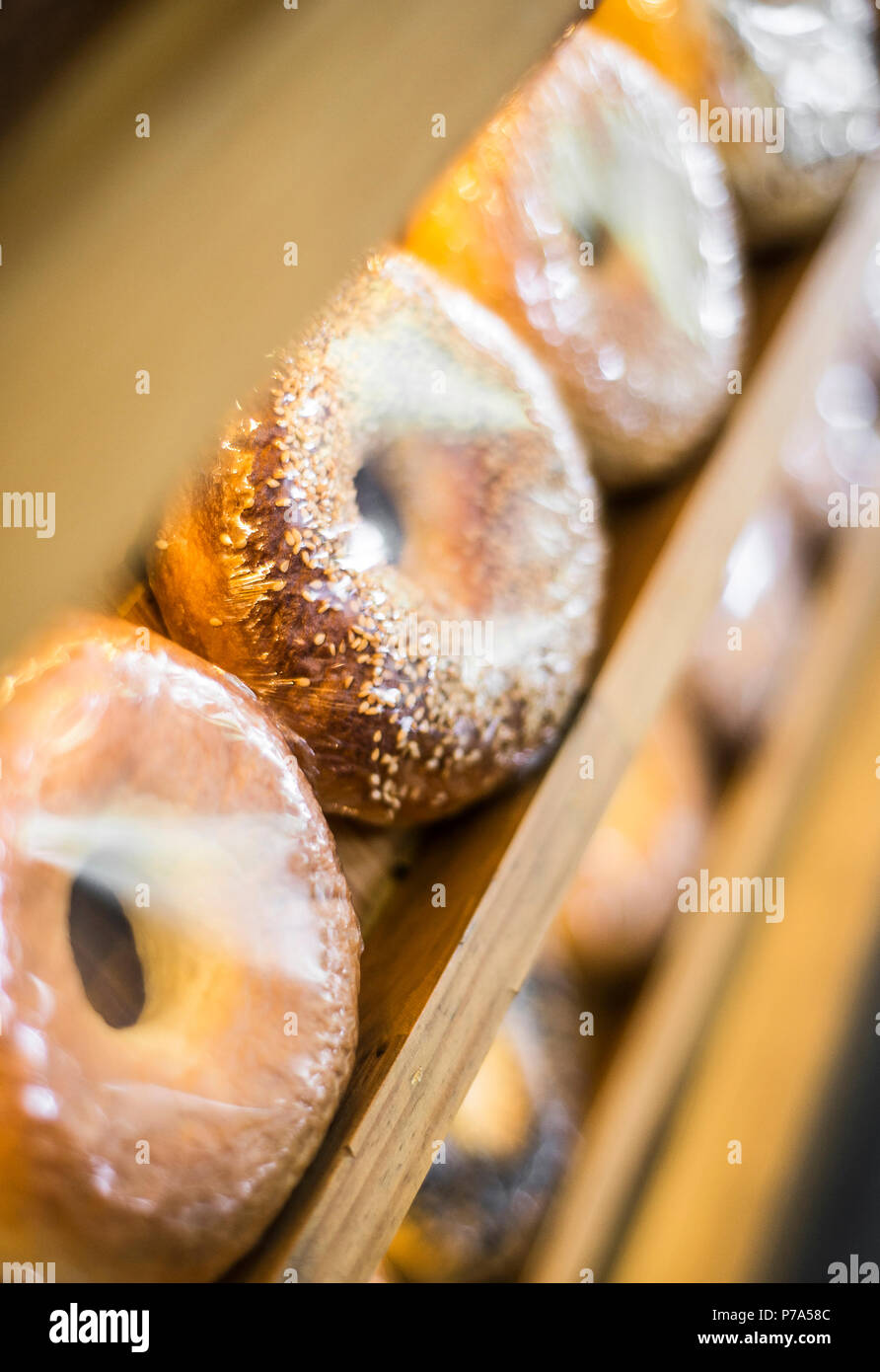 mixed fresh organic bagels in modern bakery display Stock Photo - Alamy