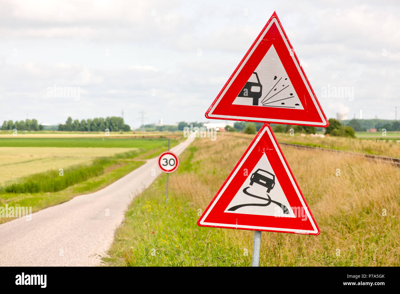 traffic warning signs along the side of an inland road in the ...