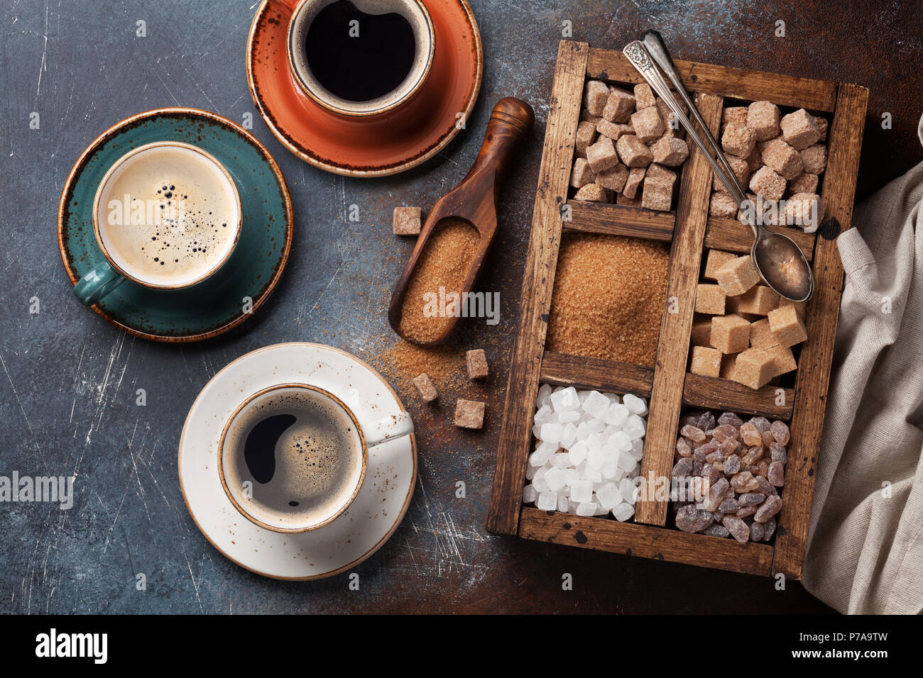 Coffee cups and various sugar. Top view Stock Photo - Alamy