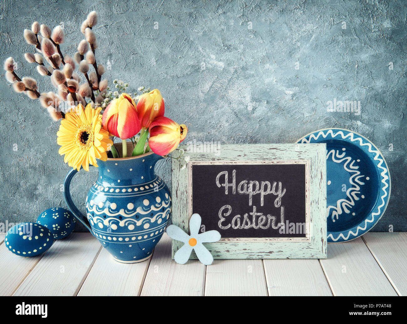 Spring flowers in blue ceramic pitcher with matching plate and Easter ...