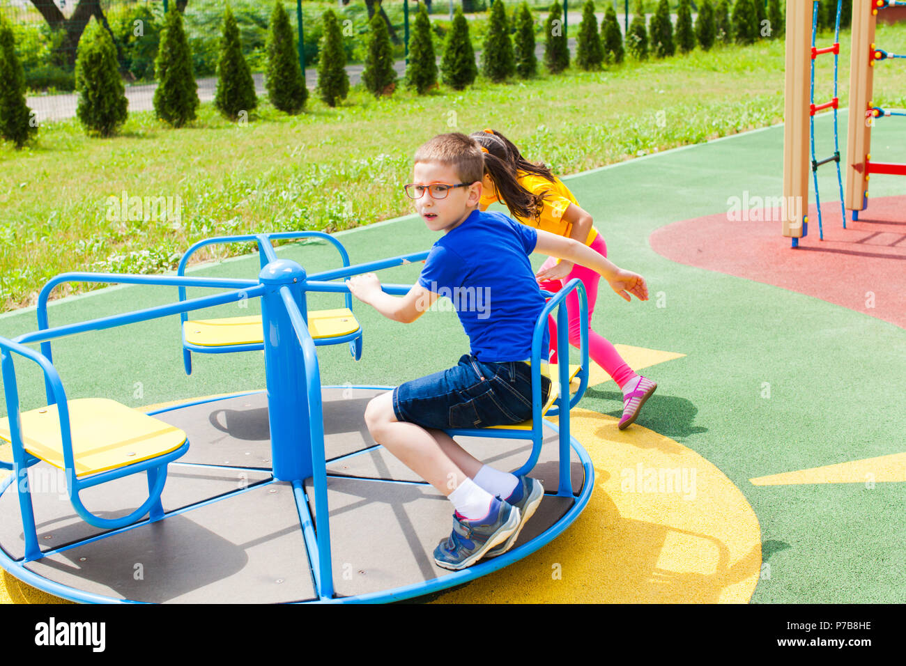 Girl pushing a boy Stock Photo - Alamy