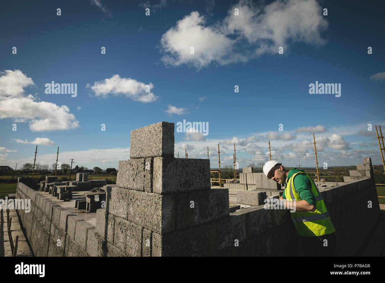 Engineer examining the wall at construction site Stock Photo - Alamy