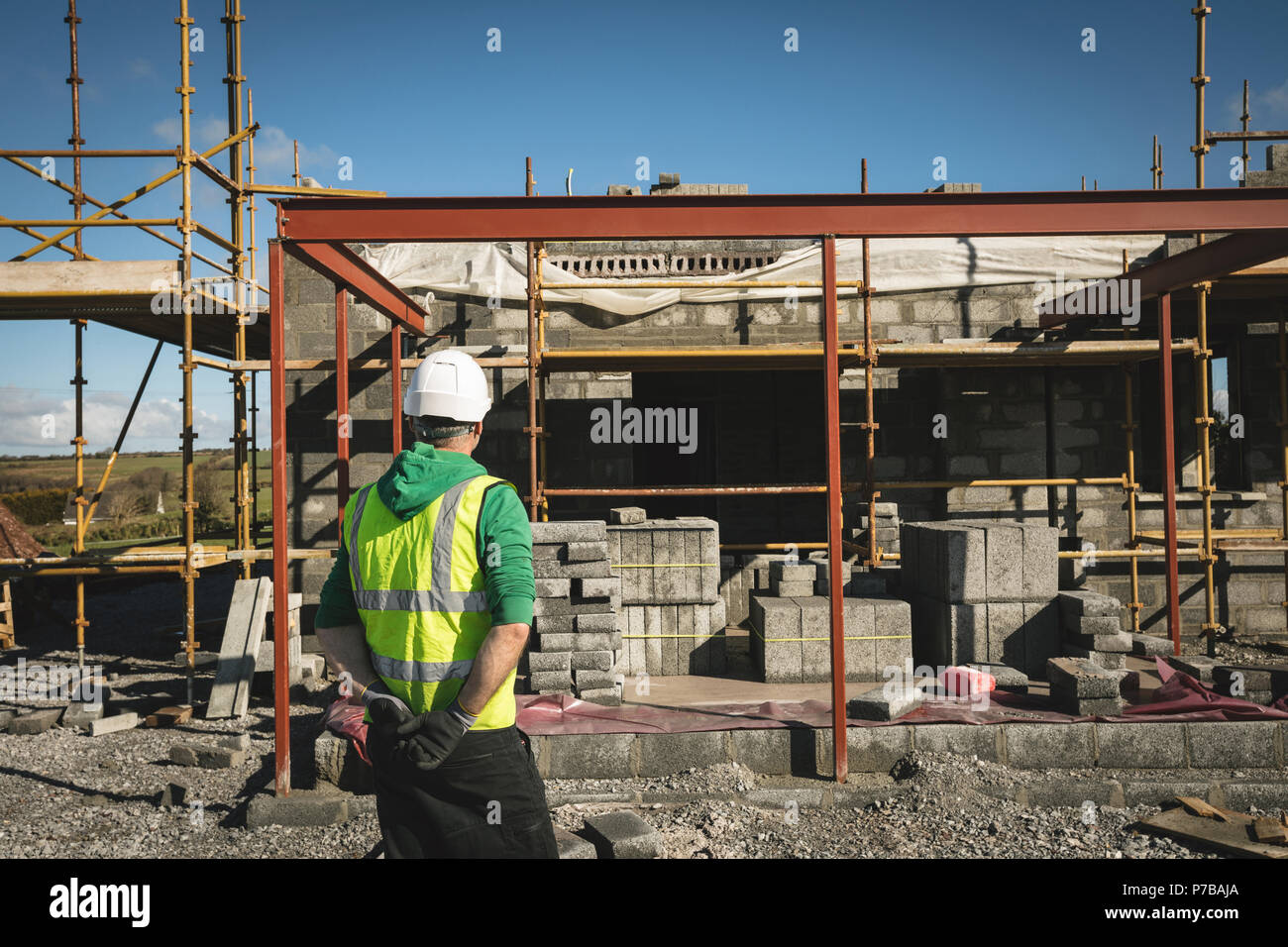 Engineer looking at the under constructed building Stock Photo - Alamy