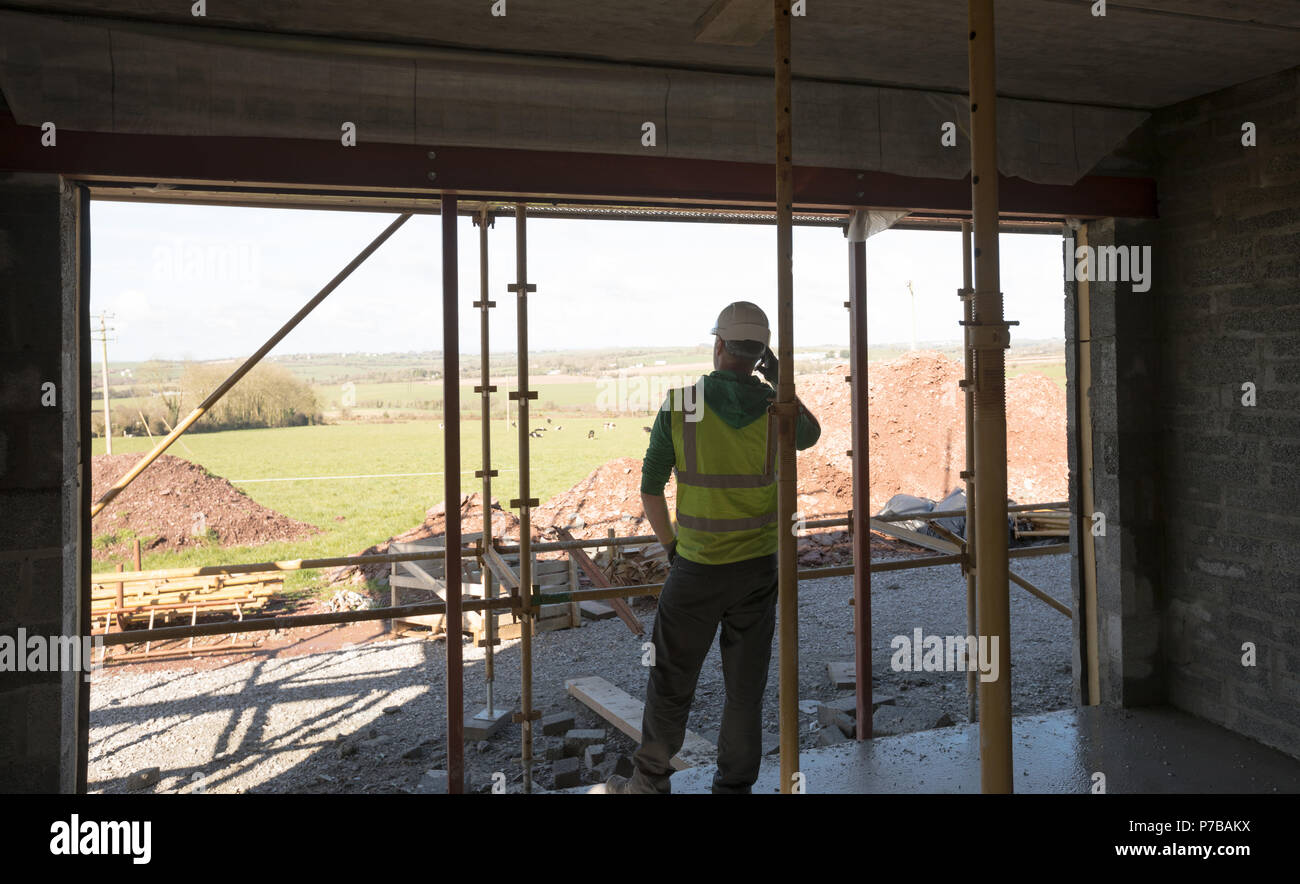Engineer talking on the phone at the construction site Stock Photo - Alamy