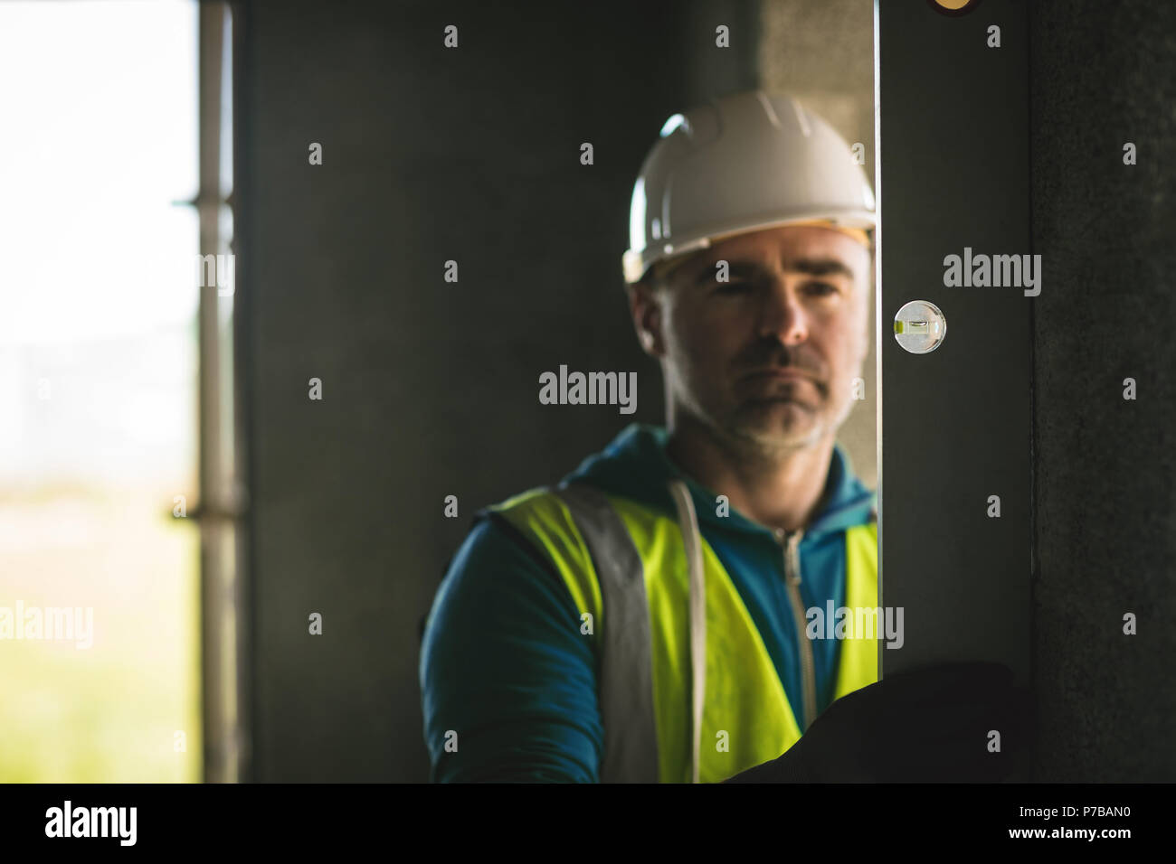 Engineer doing a level check on the wall at construction site Stock ...