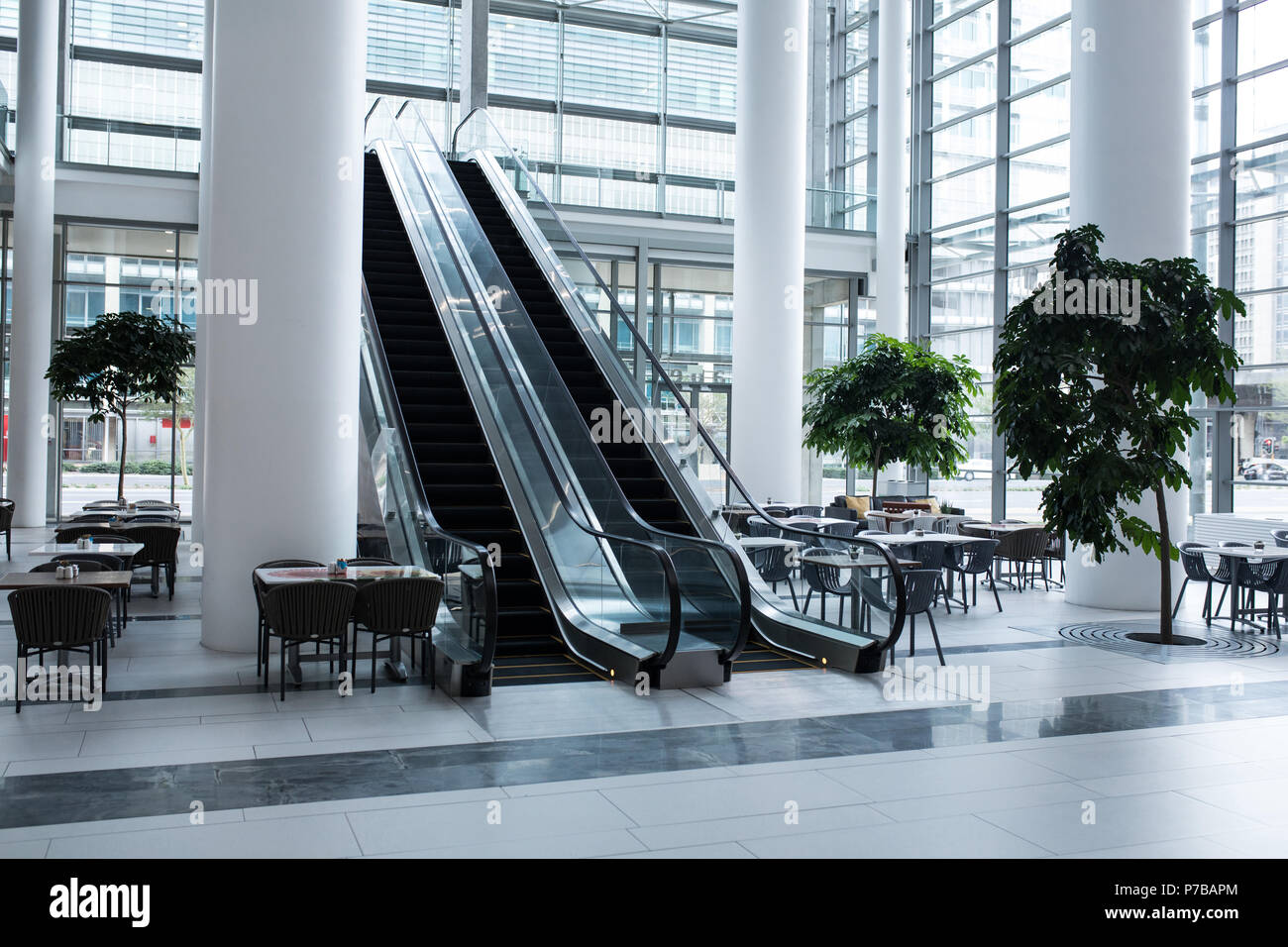 Escalator and cafeteria area inside the office Stock Photo - Alamy
