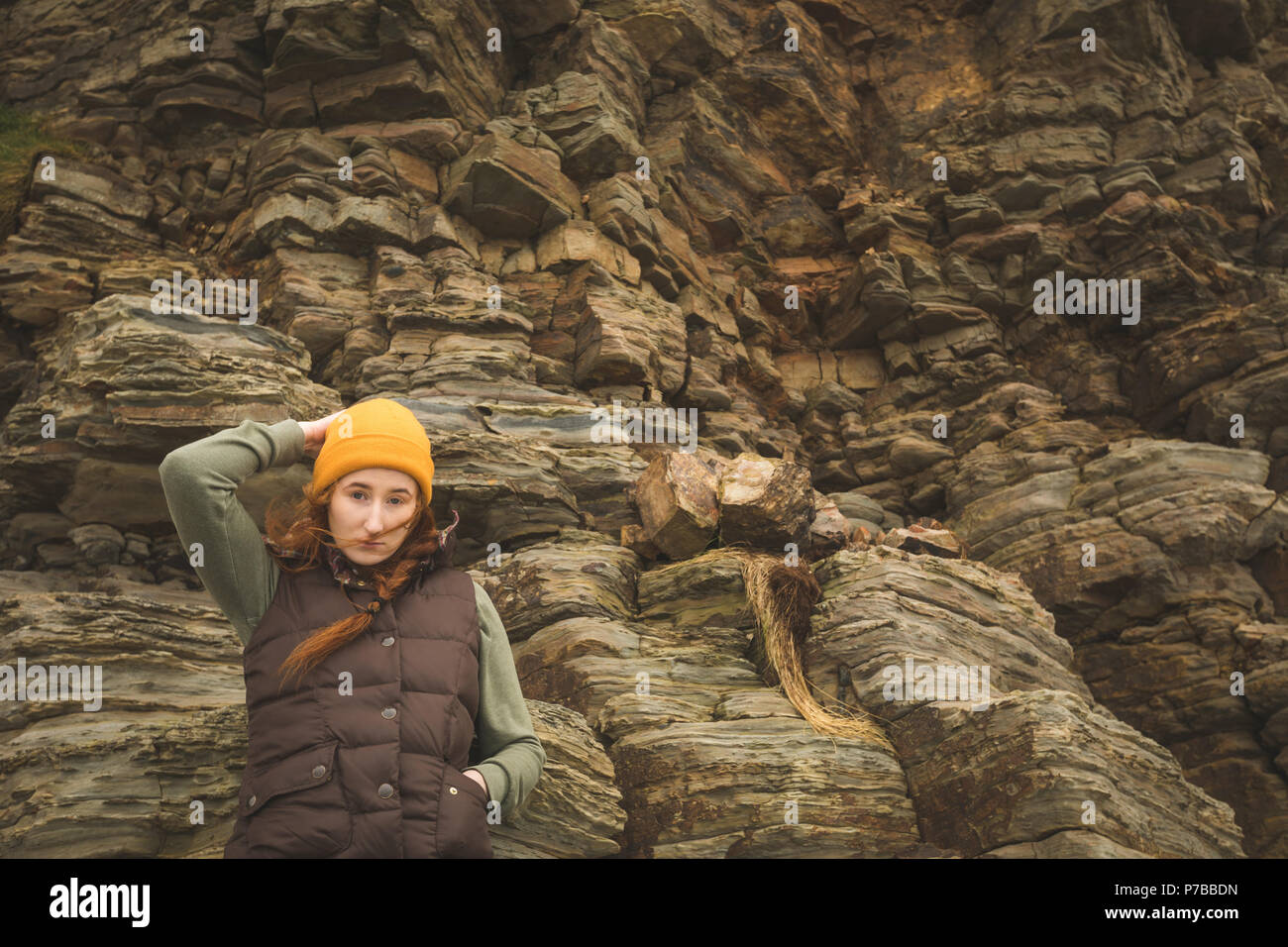 Female hiker leaning against the rock Stock Photo - Alamy