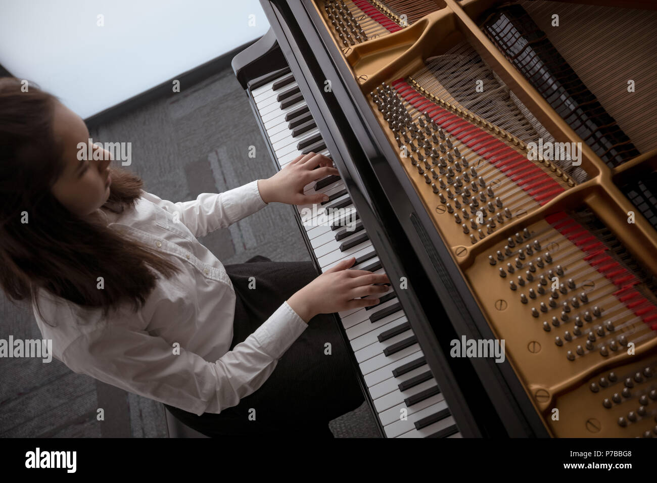 Schoolgirl playing piano in music school Stock Photo - Alamy