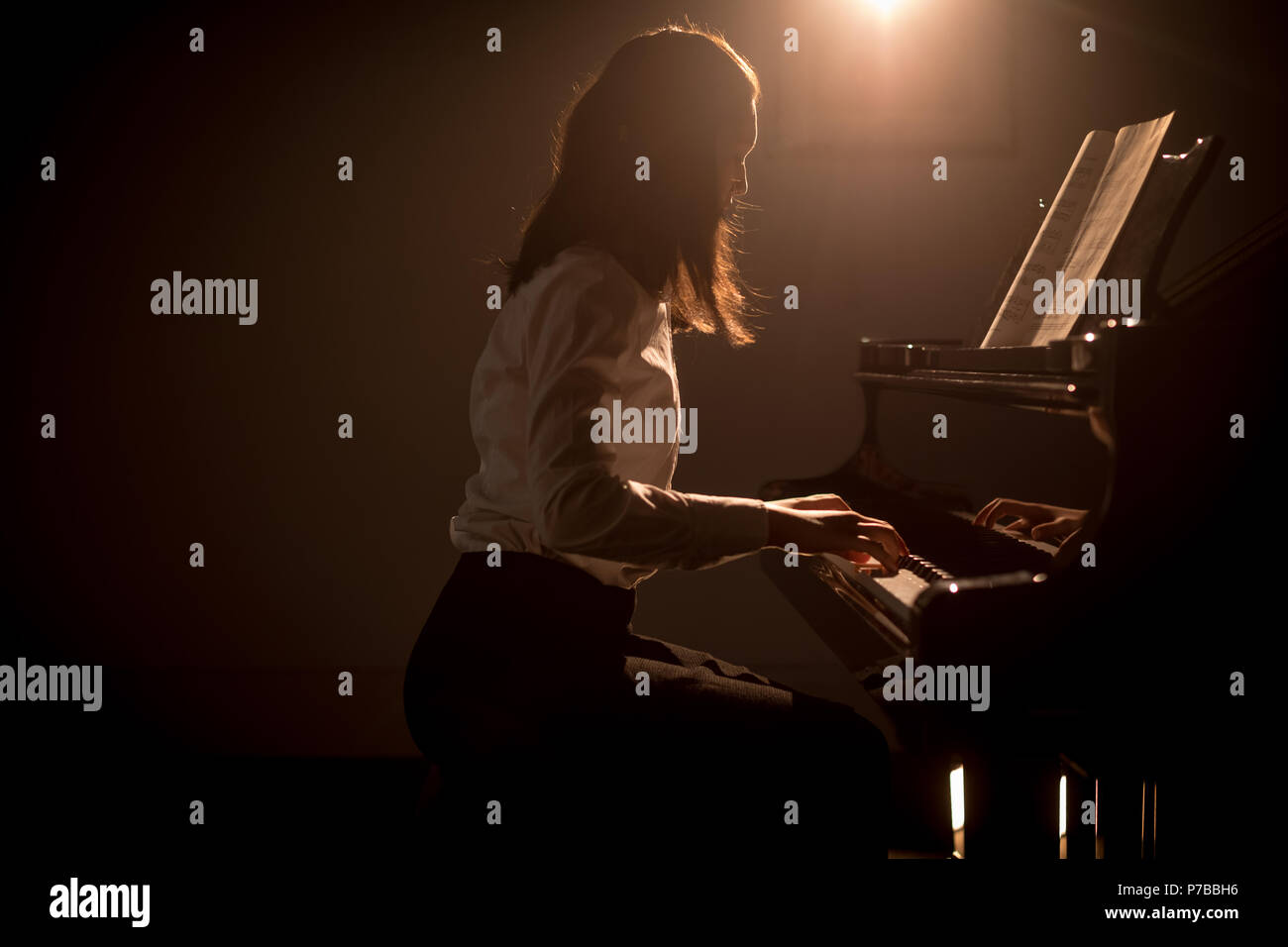 Schoolgirl playing piano in music school Stock Photo - Alamy
