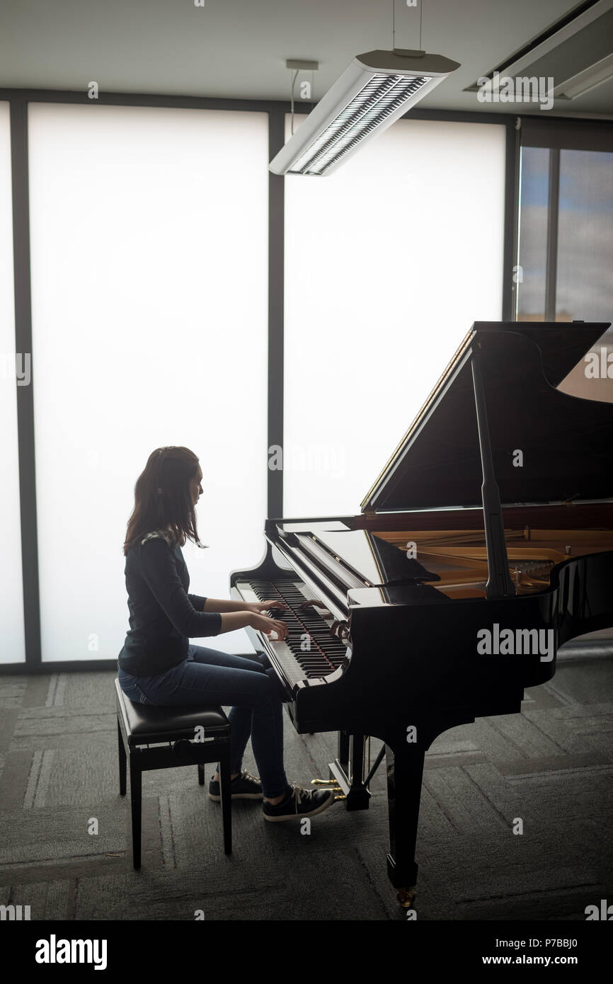 Schoolgirl playing piano in music school Stock Photo - Alamy