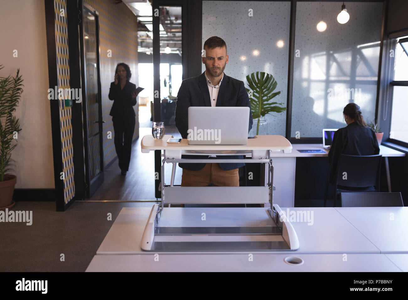 Businessman standing with laptop hi-res stock photography and images ...