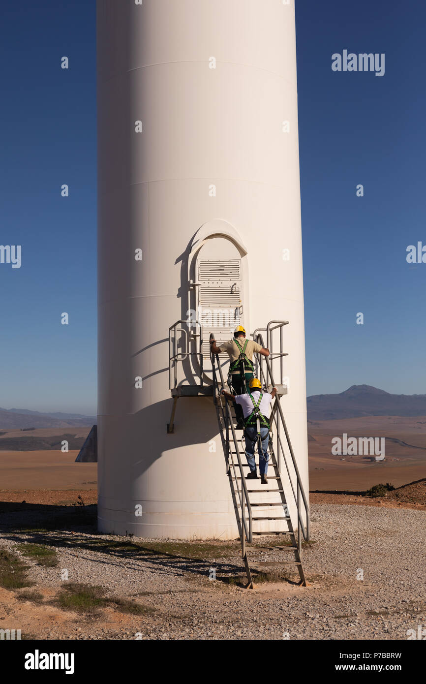 Man climbing wind turbine man wind farm hi-res stock photography and ...