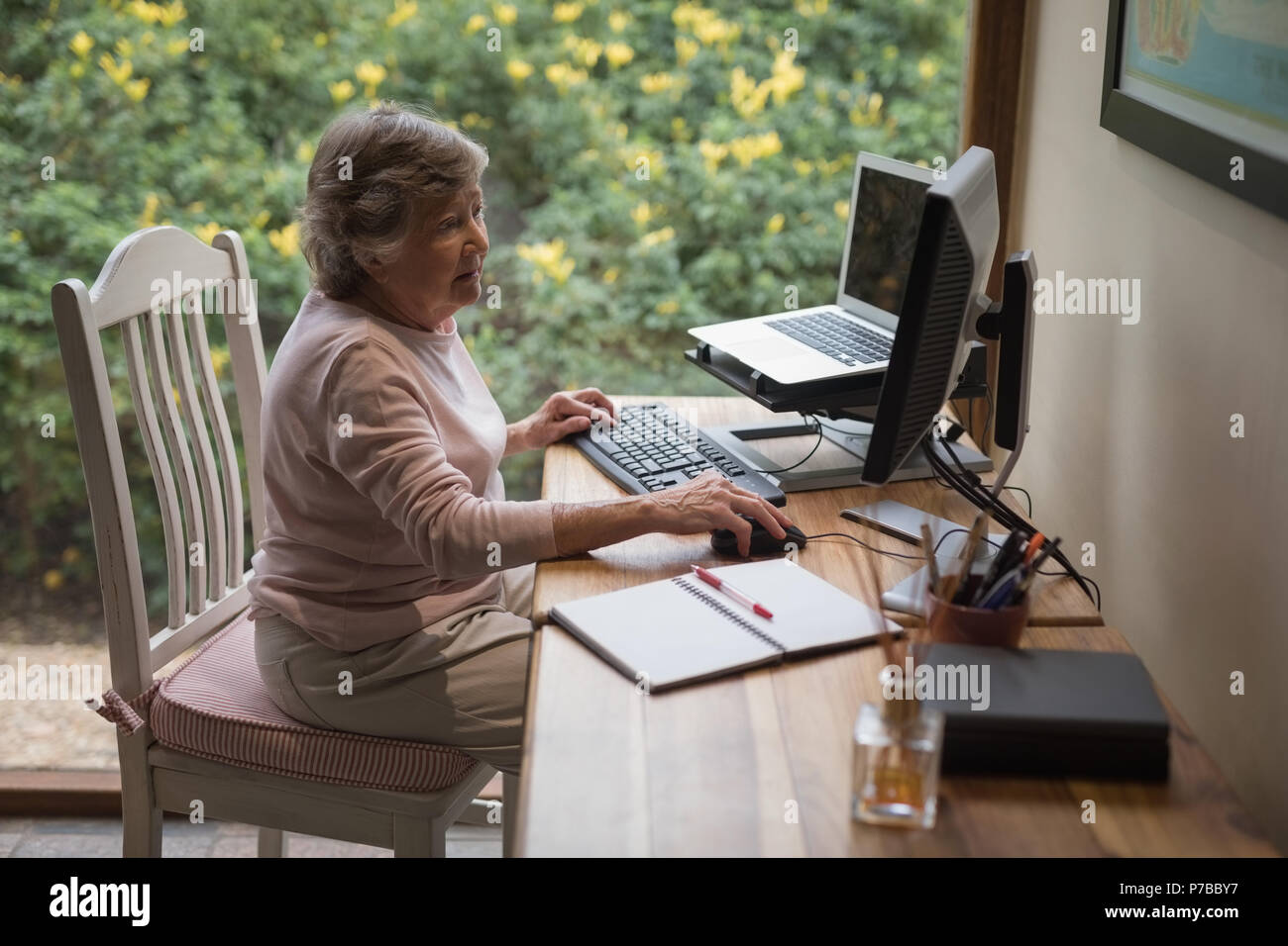 Senior woman using a desktop computer Stock Photo - Alamy