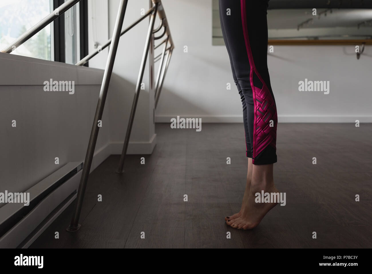 Young woman standing on tip toe Stock Photo - Alamy