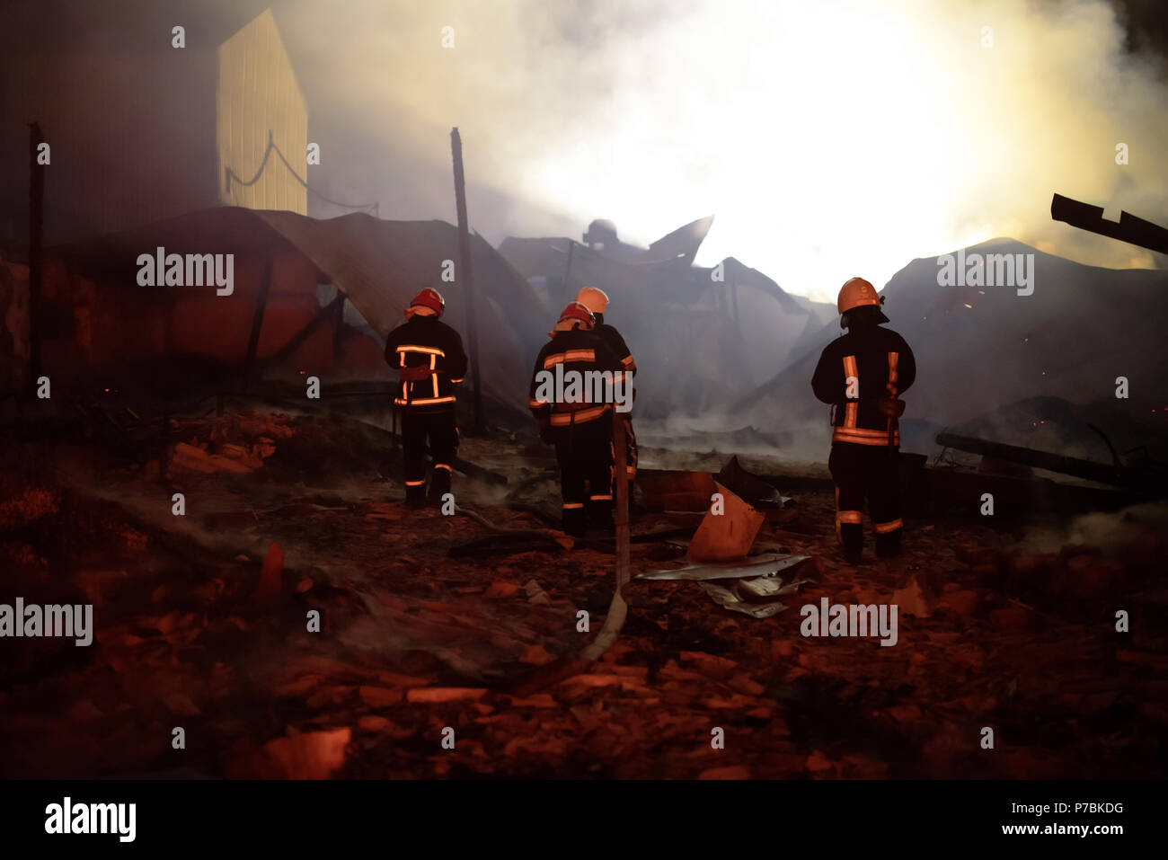 Silhouette of fireman fighting bushfire at night Stock Photo - Alamy