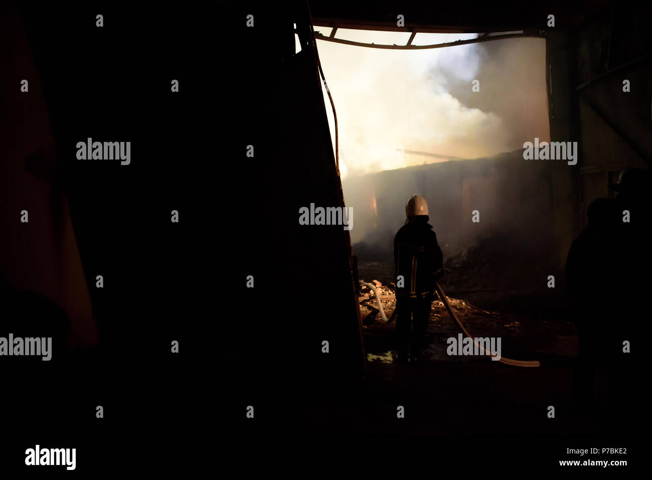 Silhouette of fireman fighting bushfire at night Stock Photo - Alamy