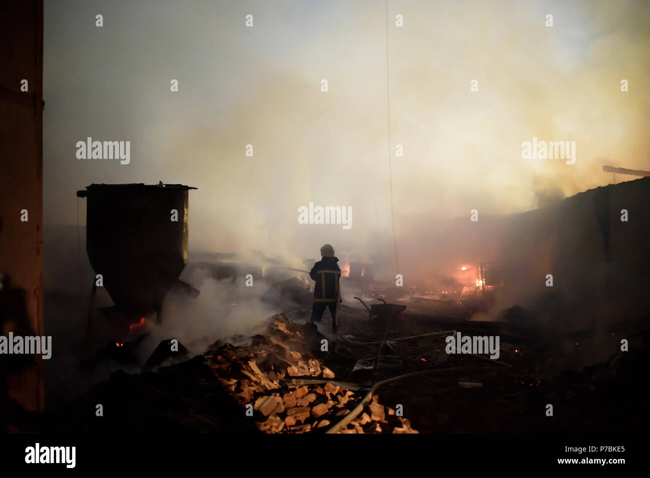 Silhouette of fireman fighting bushfire at night Stock Photo - Alamy