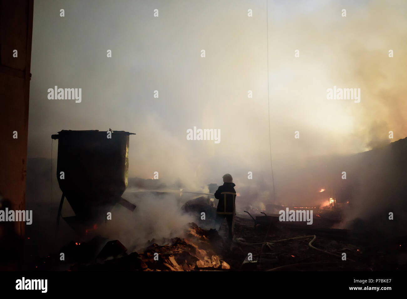 Silhouette of fireman fighting bushfire at night Stock Photo - Alamy