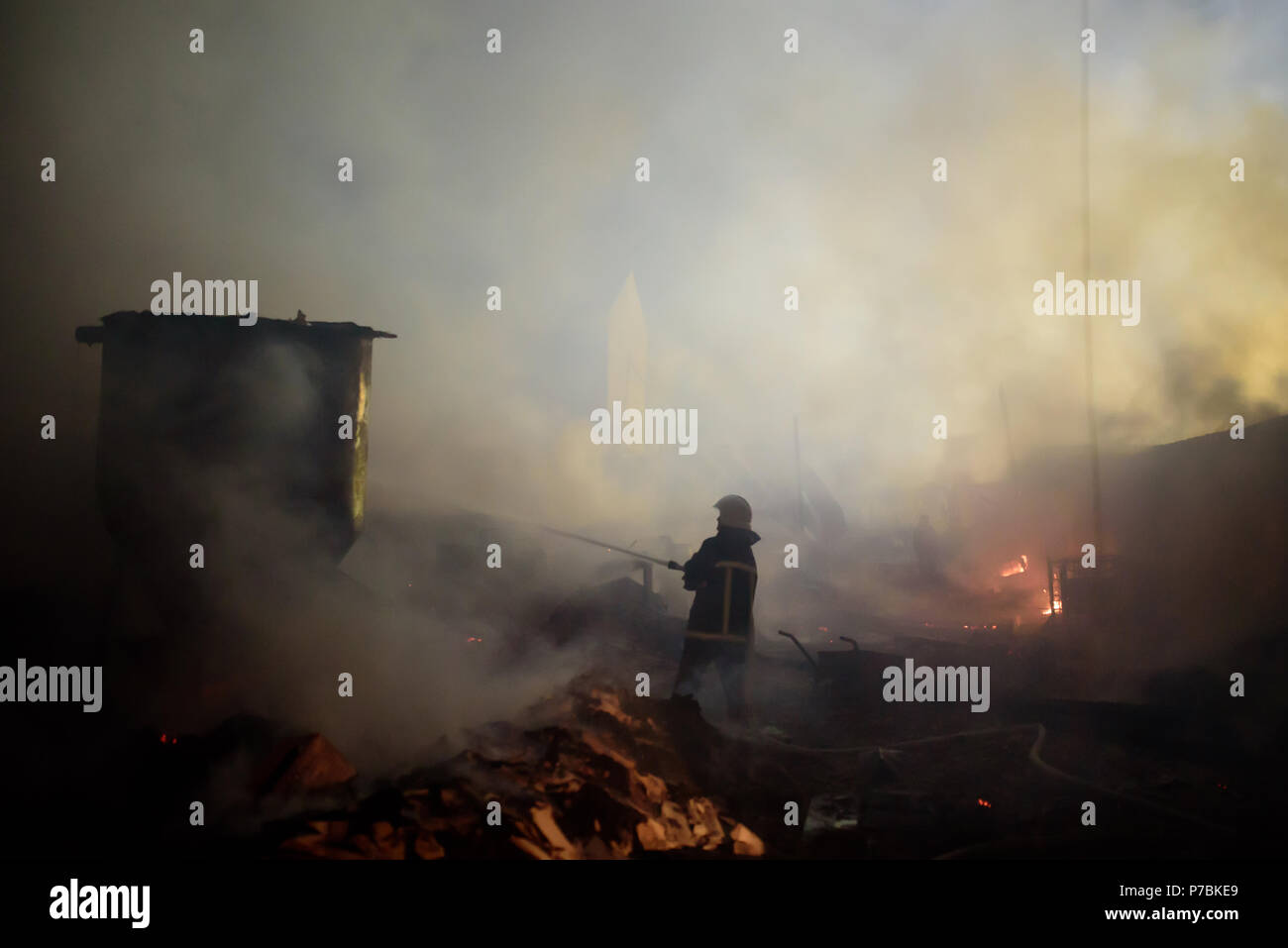 Silhouette of fireman fighting bushfire at night Stock Photo - Alamy