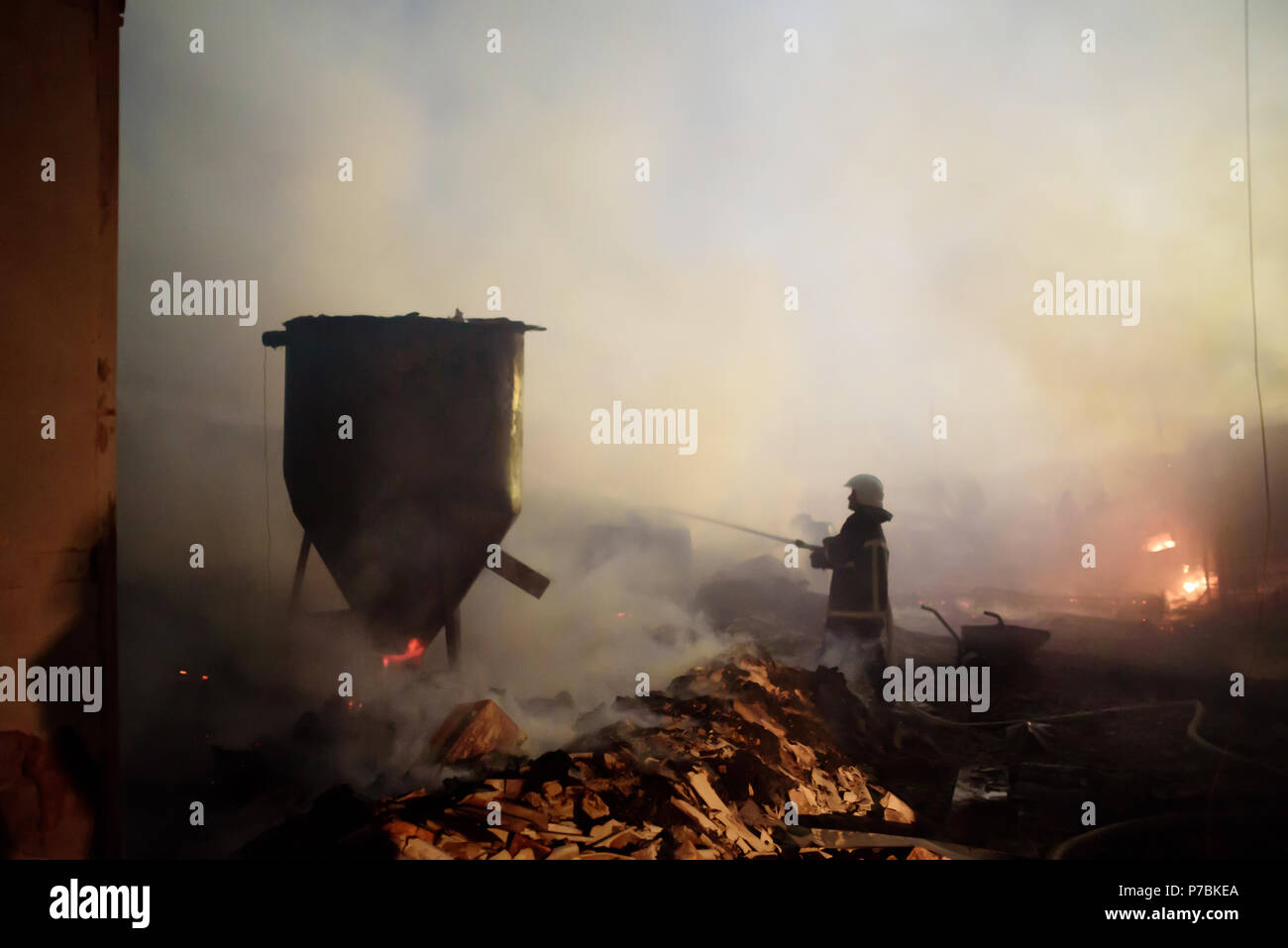 Silhouette of fireman fighting bushfire at night Stock Photo - Alamy