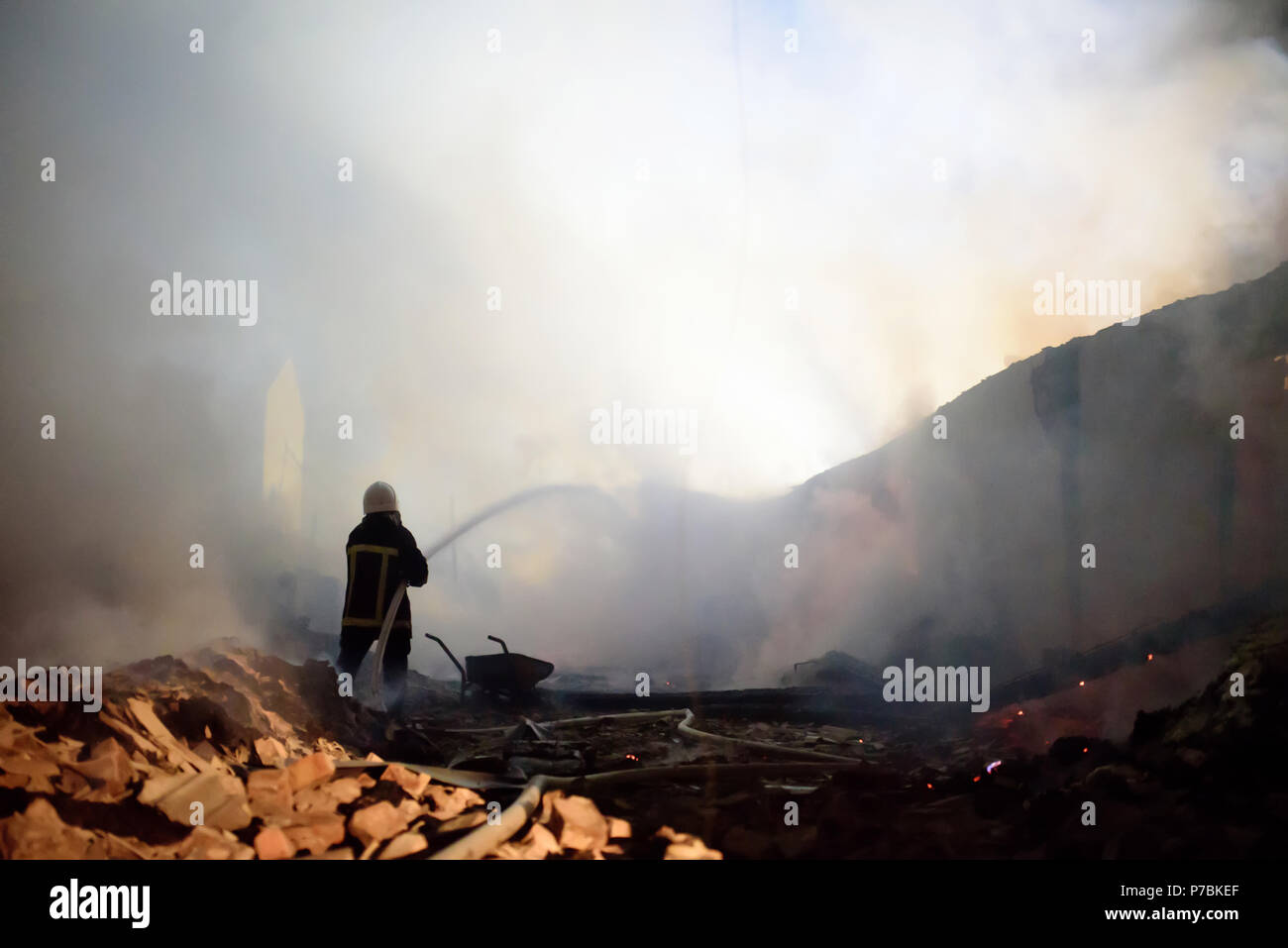 Silhouette of fireman fighting bushfire at night Stock Photo - Alamy