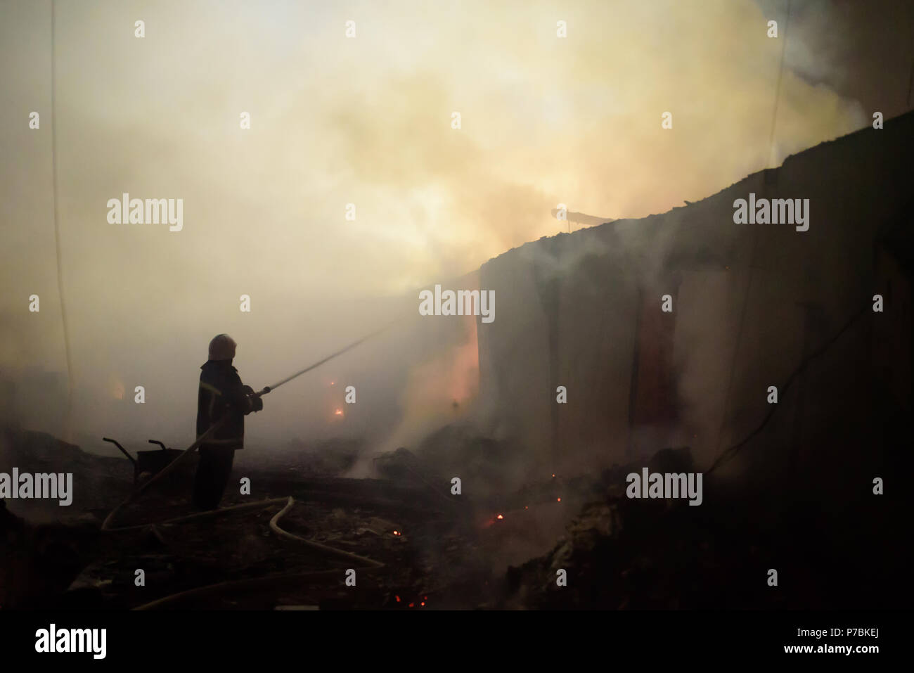 Silhouette of fireman fighting bushfire at night Stock Photo - Alamy