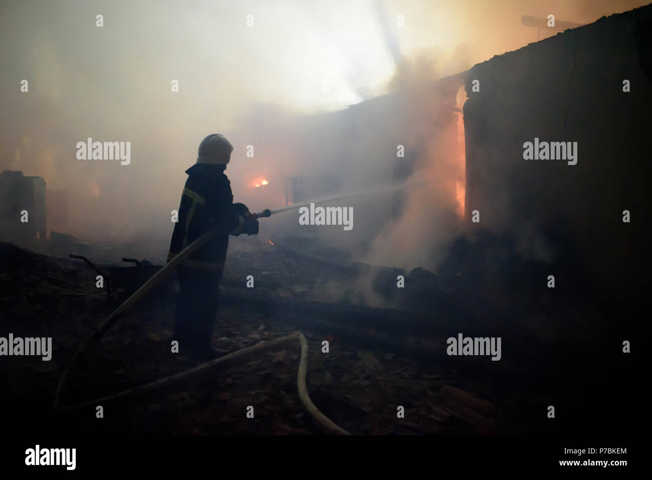 Silhouette of fireman fighting bushfire at night Stock Photo - Alamy