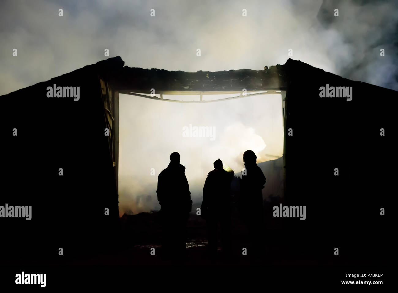 Silhouette of fireman fighting bushfire at night Stock Photo - Alamy