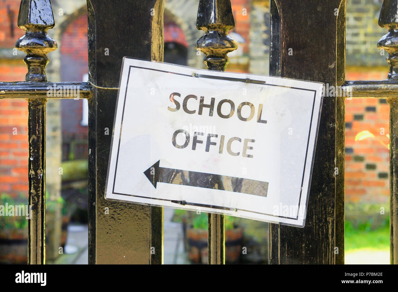 A laminated school office sign on a wooden gate Stock Photo - Alamy
