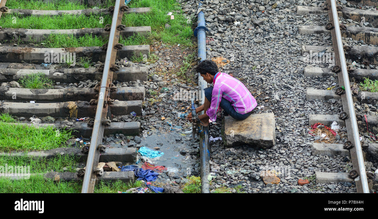 Gaya, India - Jul 9, 2015. A man washing hands on rail track in Gaya ...