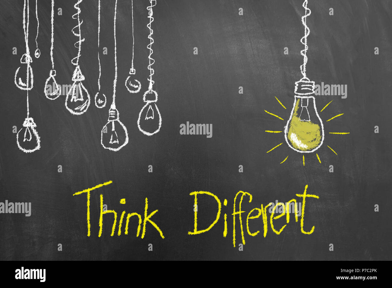 Think different concept with light bulbs drawing and text on chalkboard ...