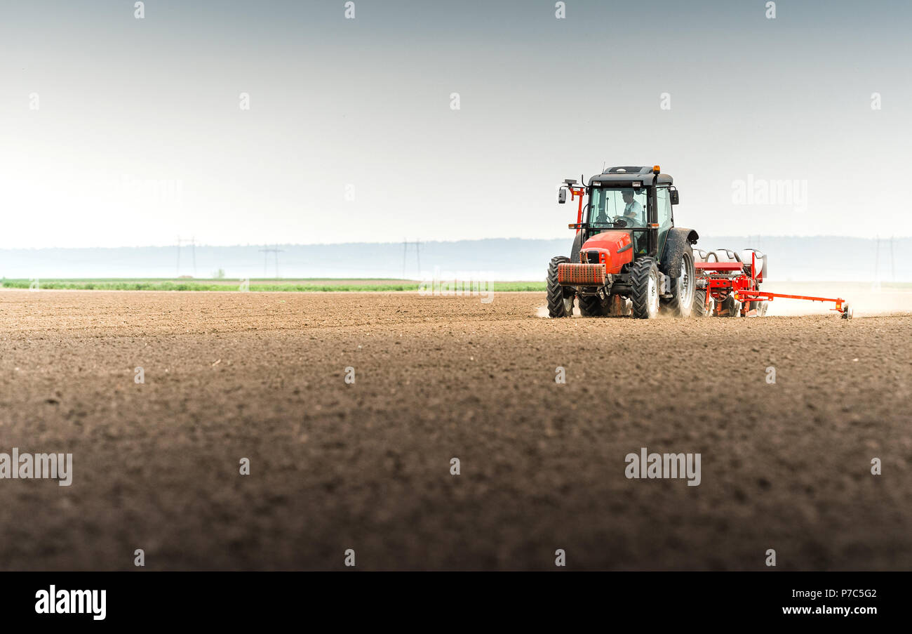 Farmer seeding crops at field Stock Photo - Alamy