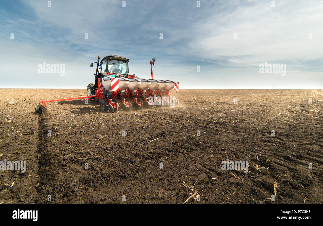 Farmer seeding crops at field Stock Photo - Alamy