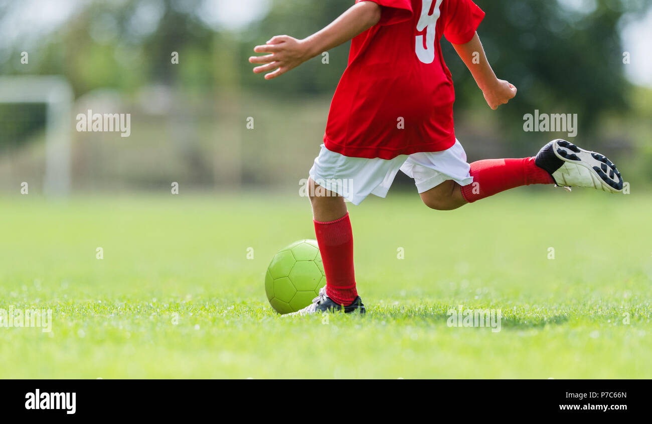 Boy kicking ball 9 hi-res stock photography and images - Alamy