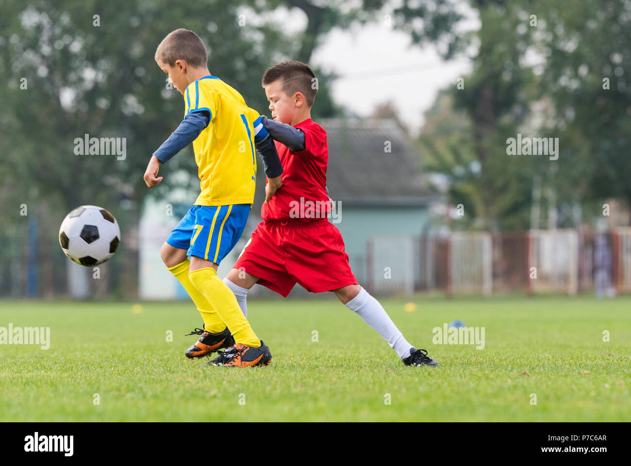 boys kicking football on the sports field Stock Photo - Alamy