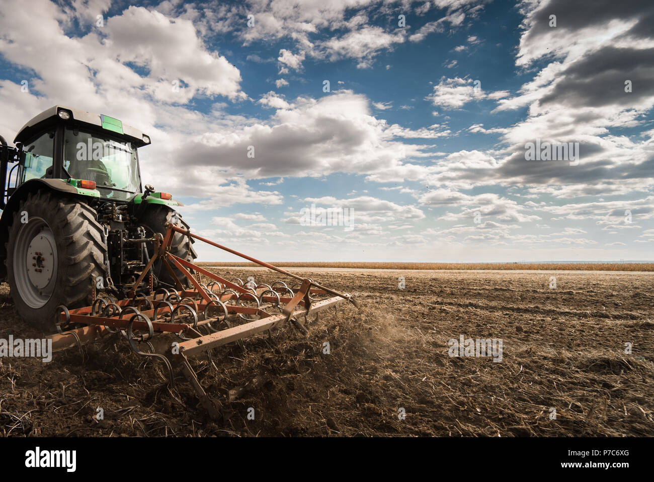 Tractor preparing land for sowing Stock Photo - Alamy