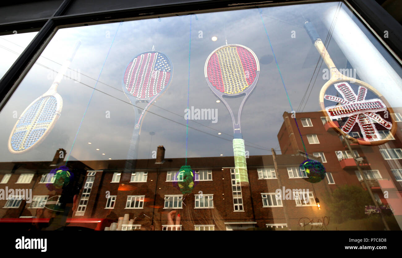 Tennis rackets and balls are displayed in a window on day four of the ...