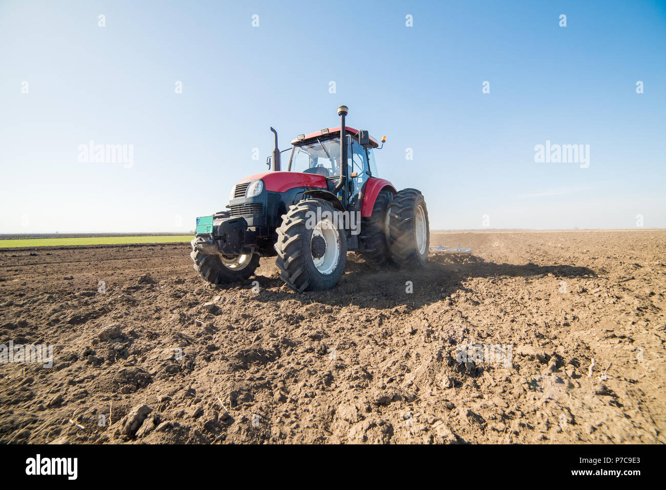 Tractor preparing land for sowing Stock Photo - Alamy