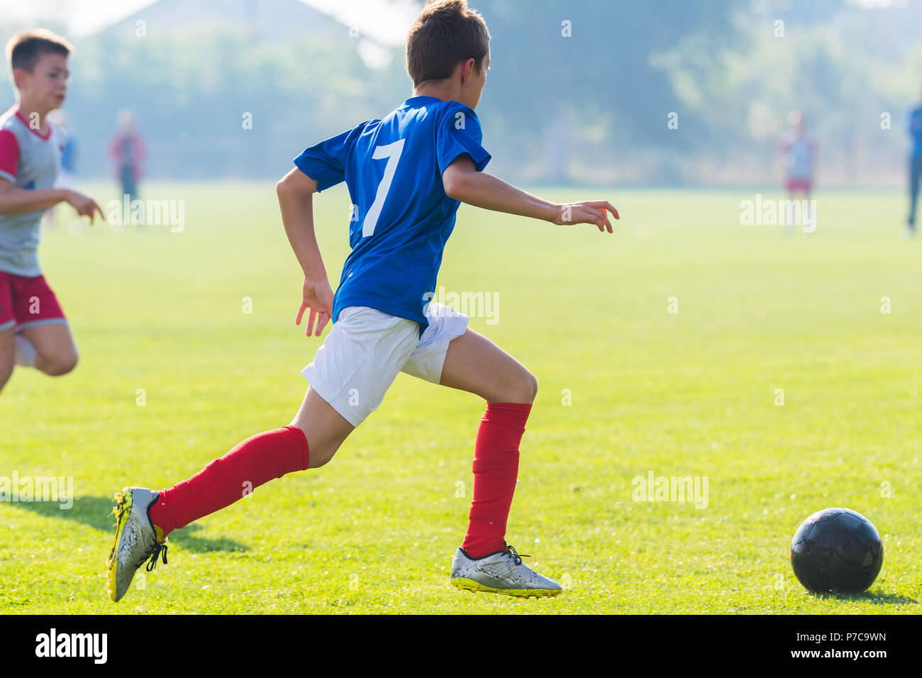 Boy kicking ball 9 hi-res stock photography and images - Alamy