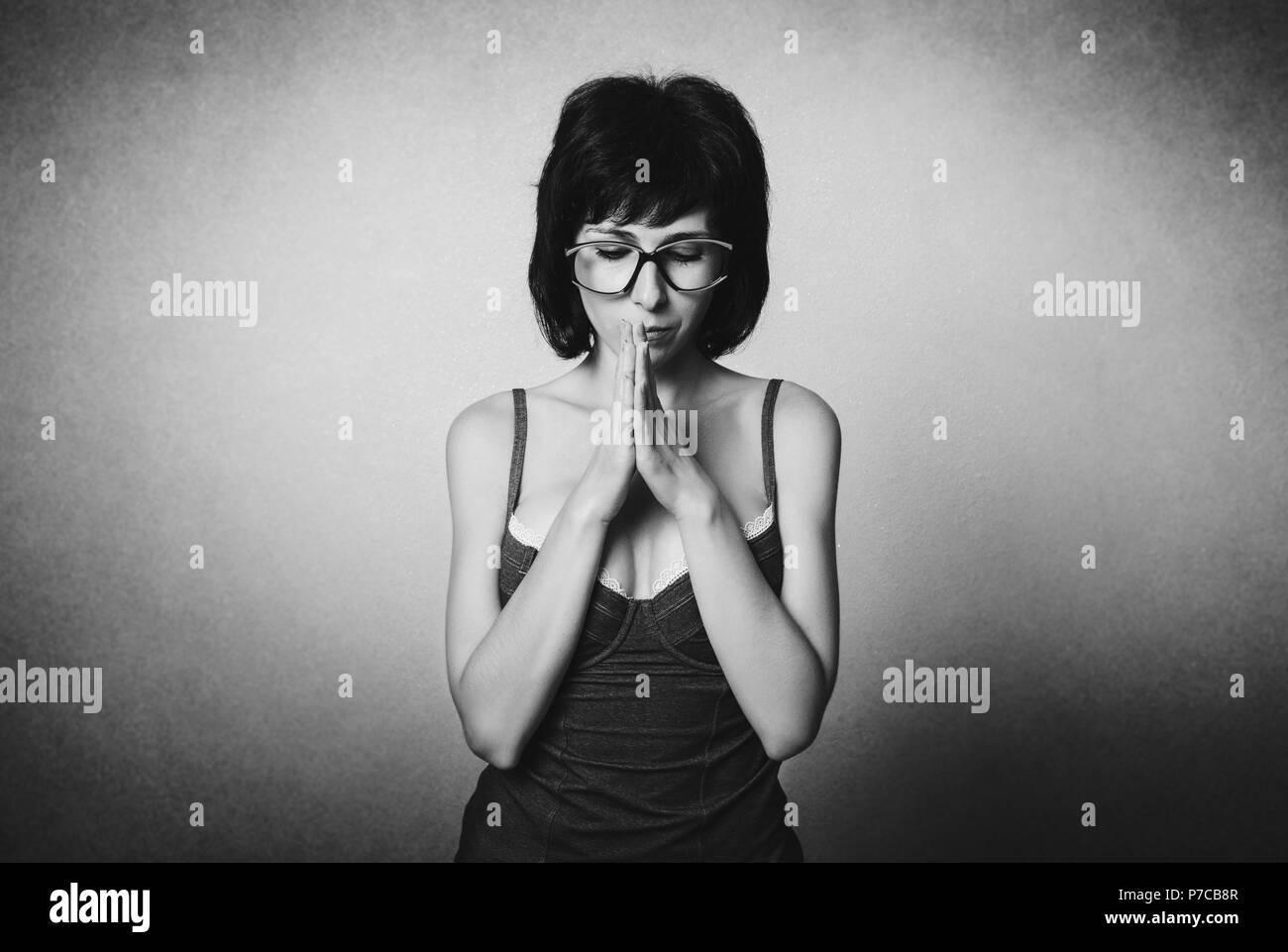 Pretty woman with praying sign Stock Photo - Alamy