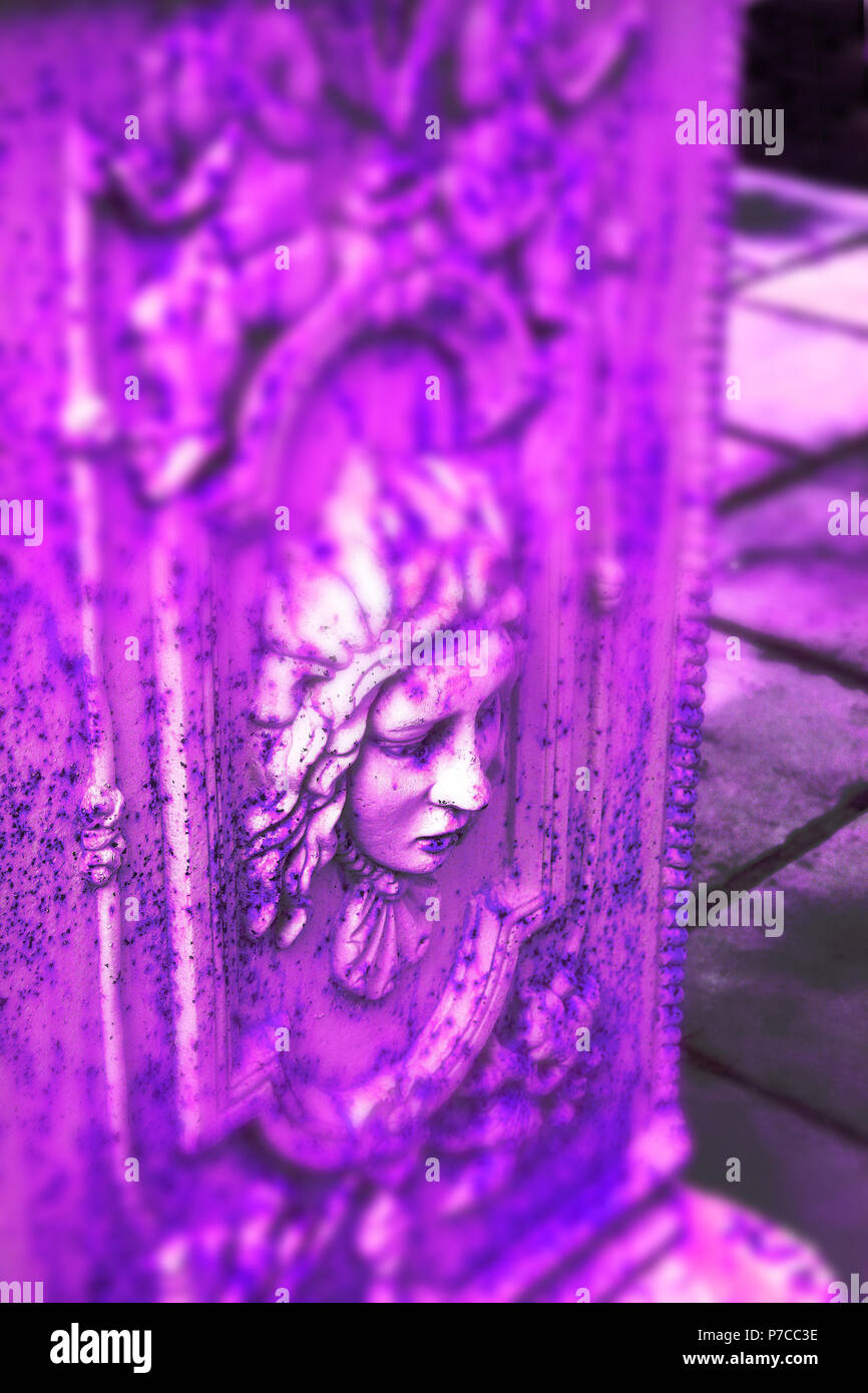 A rusty purple iron face looks out Stock Photo - Alamy