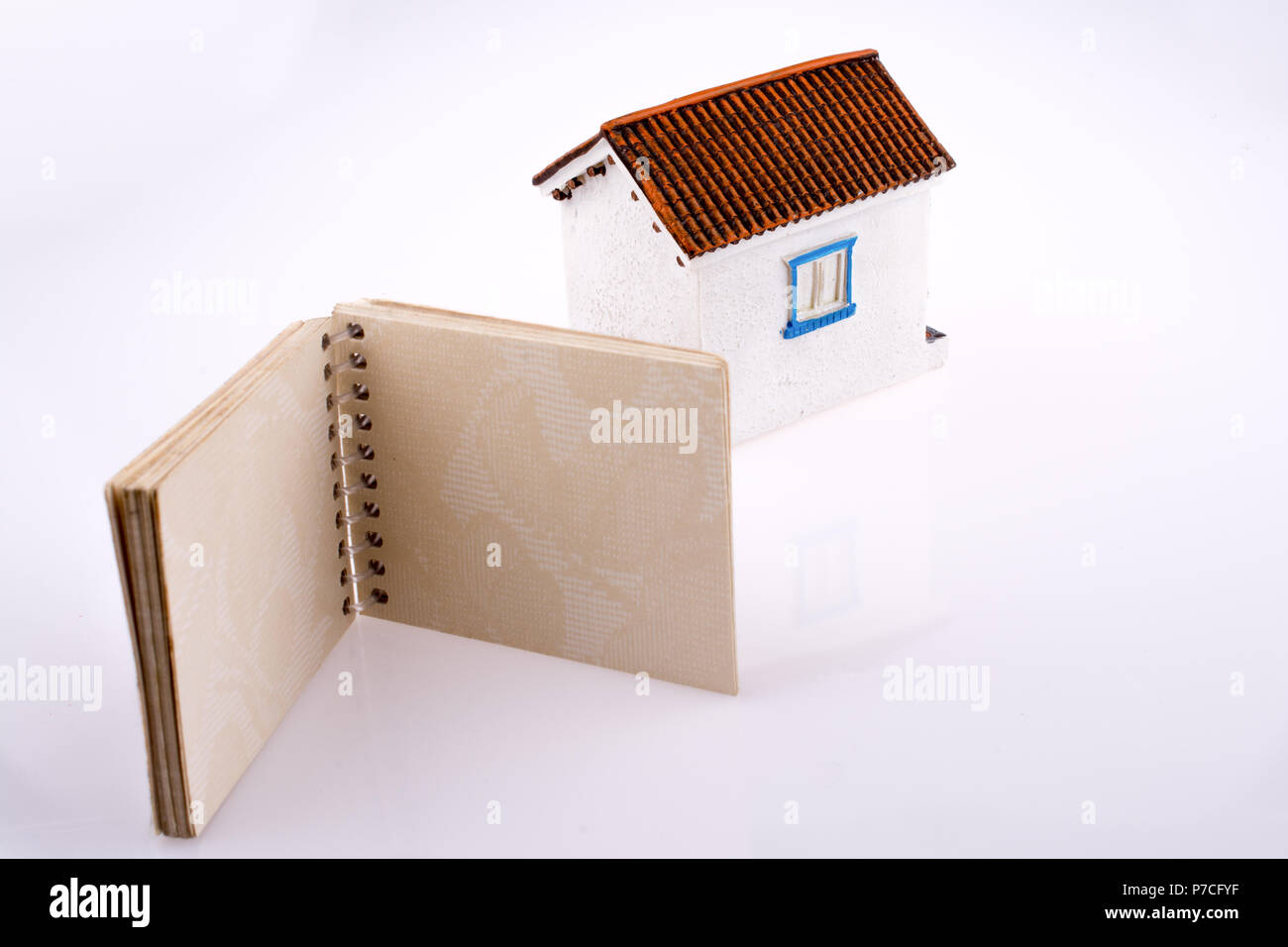 House andspiral notebook on a white background Stock Photo - Alamy