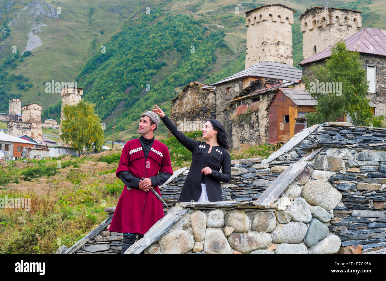 Georgian couple from a folkloric group on a stone bridge in front of ...