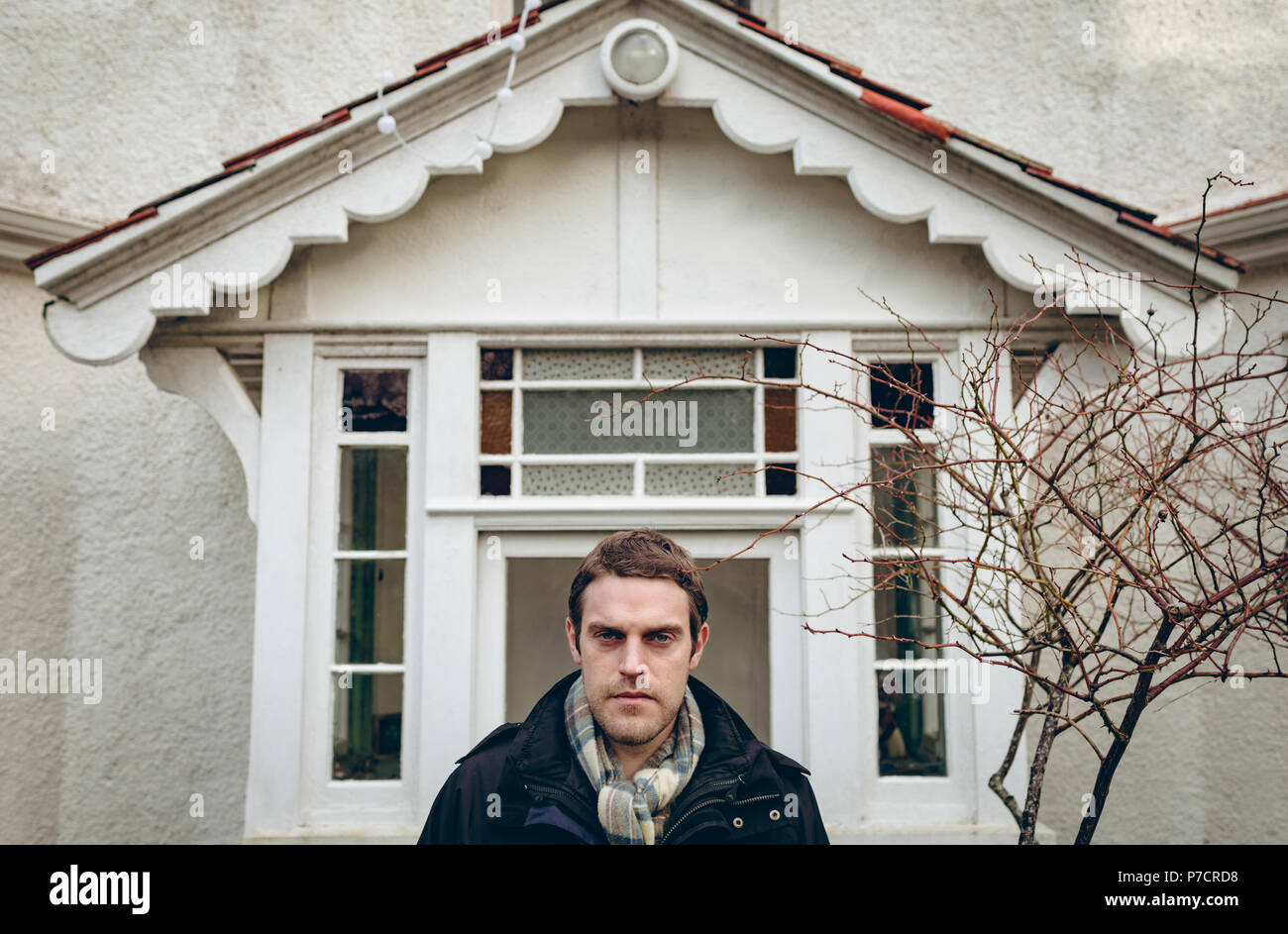 Man standing in the backyard of his house Stock Photo - Alamy